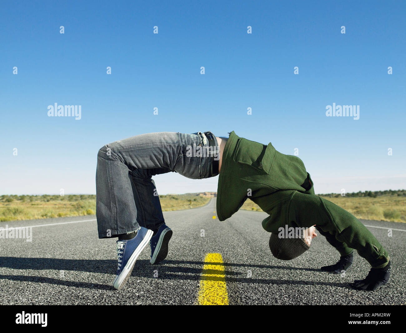 Man doing bridge on highway Stock Photo - Alamy