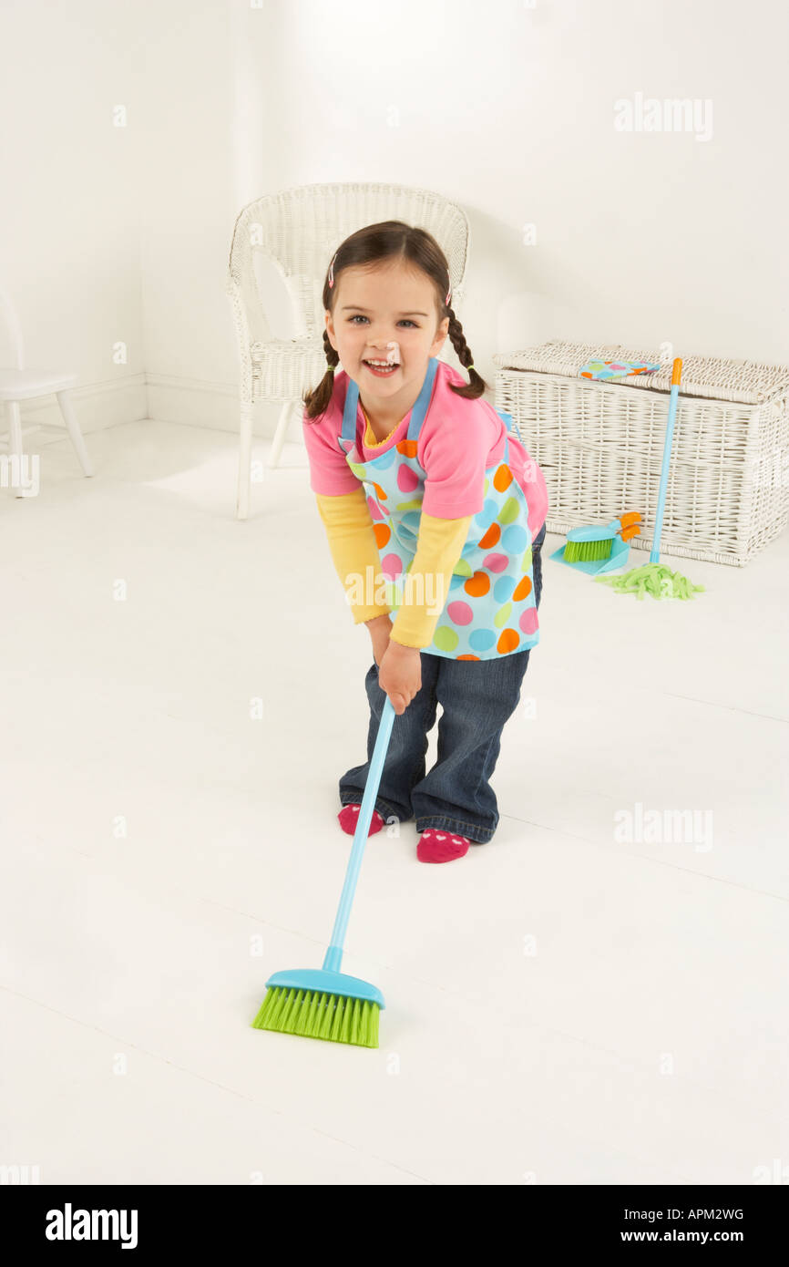 a girl plays cleaning with a toy broom Stock Photo - Alamy