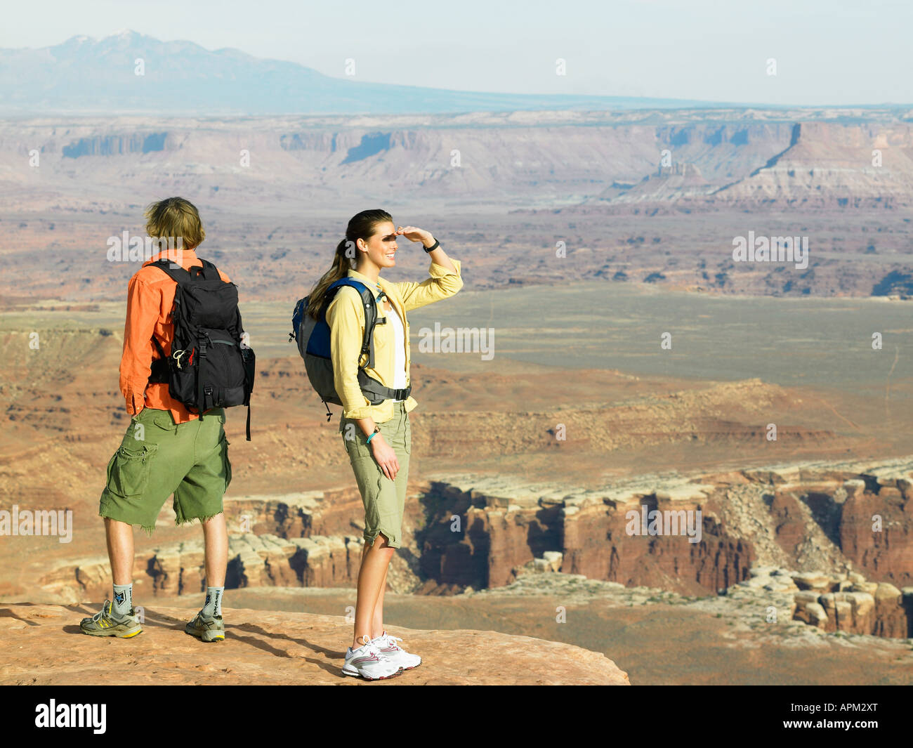 Two hikers looking at rock strata Stock Photo - Alamy