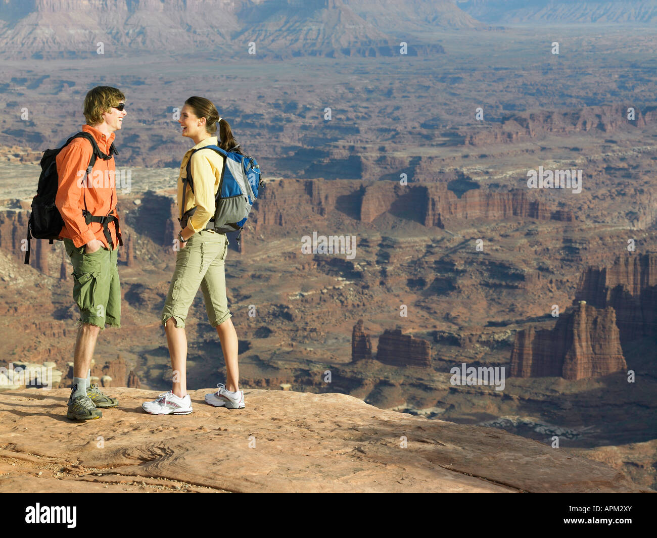 Two hikers looking at rock strata Stock Photo - Alamy