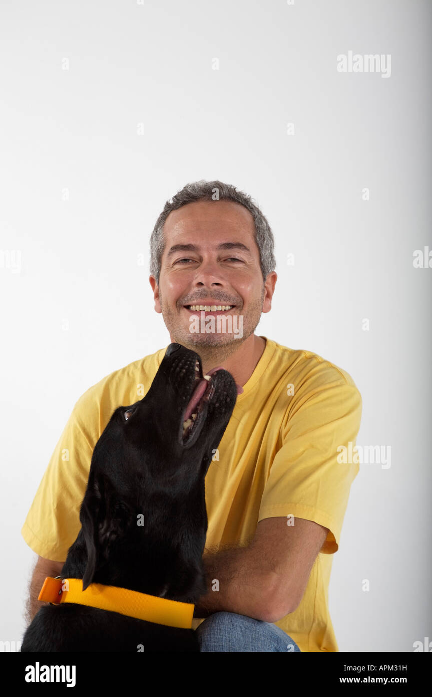 Owner playing with black Labrador dog Stock Photo - Alamy