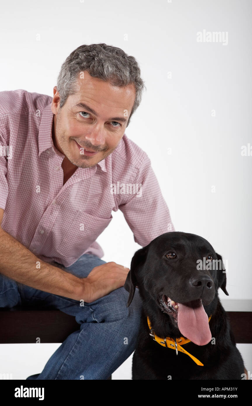 Black Labrador dog and owner Stock Photo - Alamy