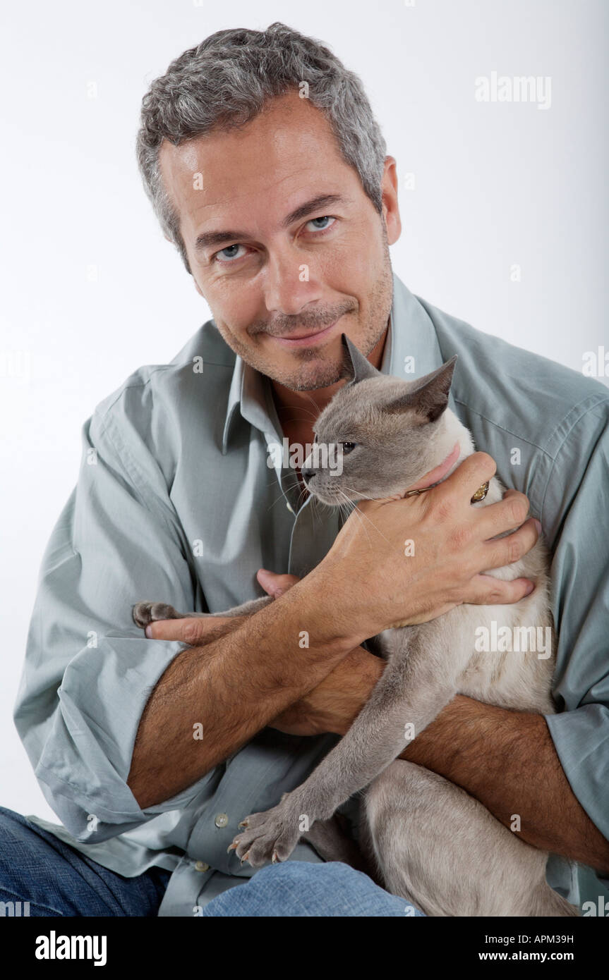 Man with Siamese cat Stock Photo - Alamy