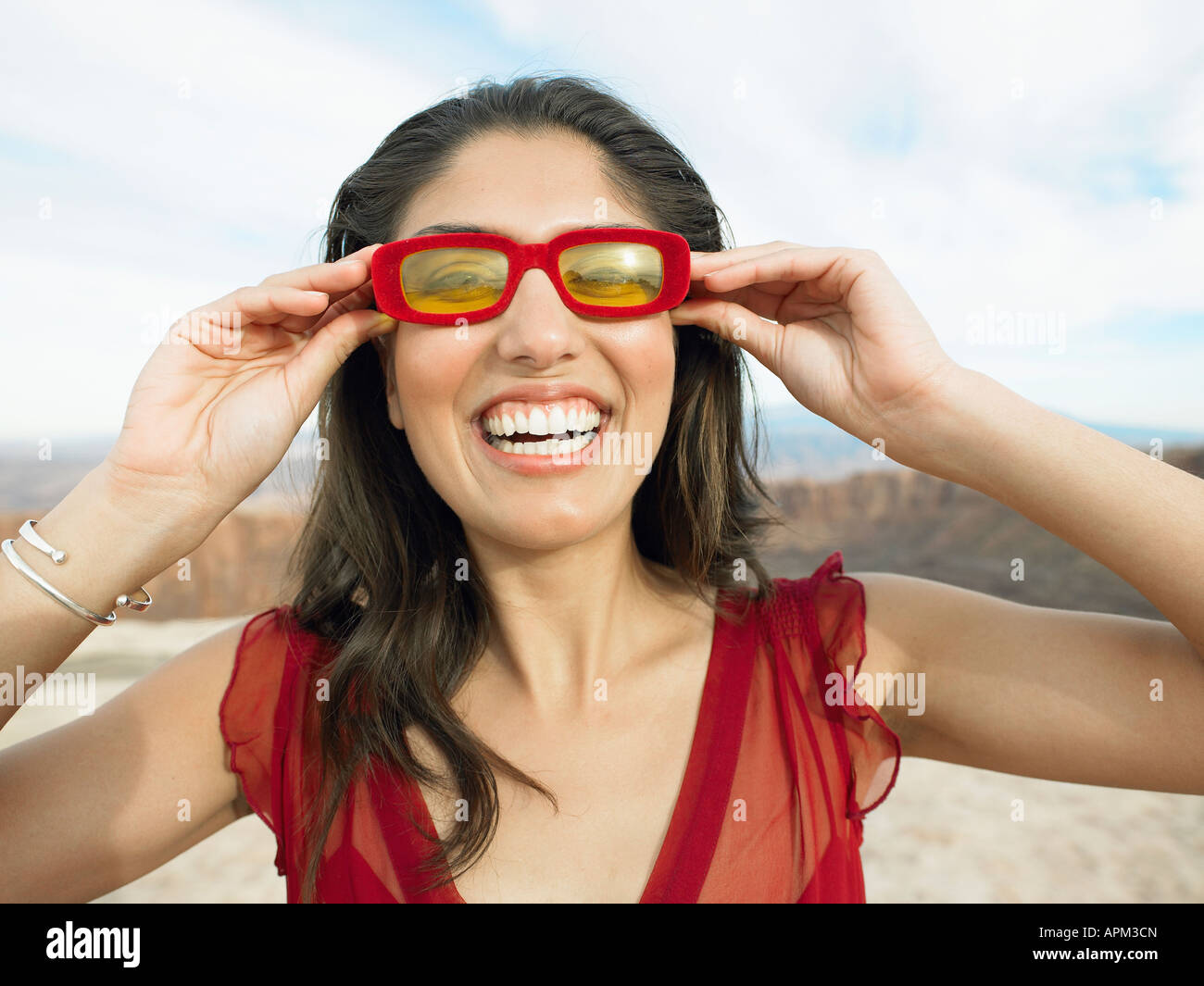 Mid adult woman trying silly sunglasses on, portrait Stock Photo - Alamy