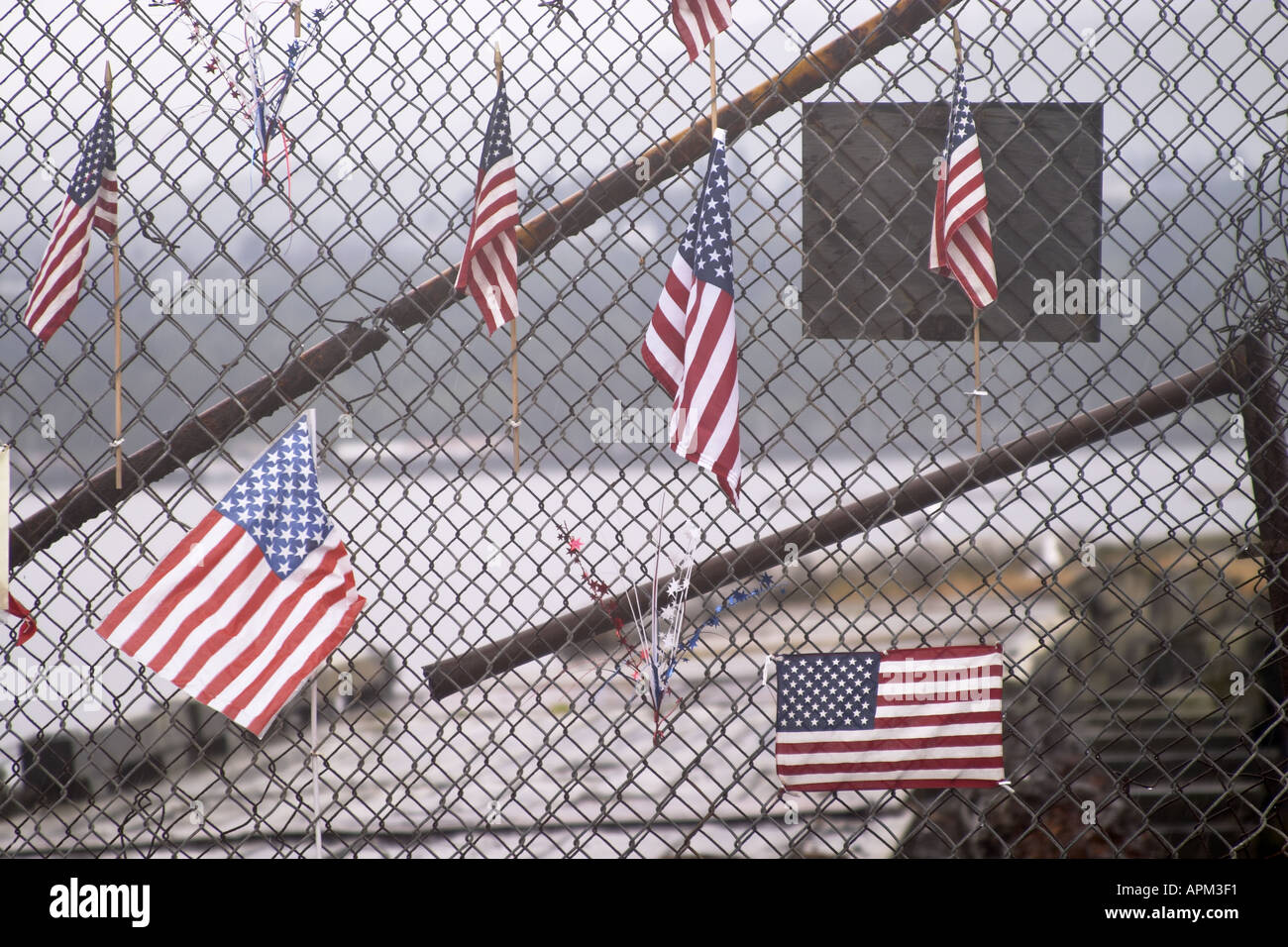 US flags on chain link fence Port Angeles Olympic Peninsula Clallam ...