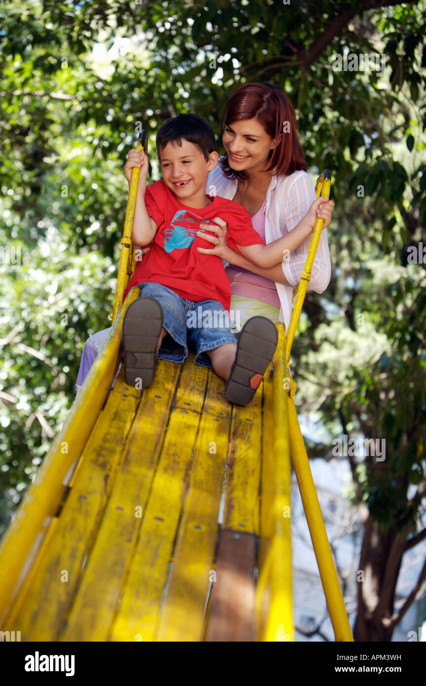 Mother and children in playground Stock Photo - Alamy