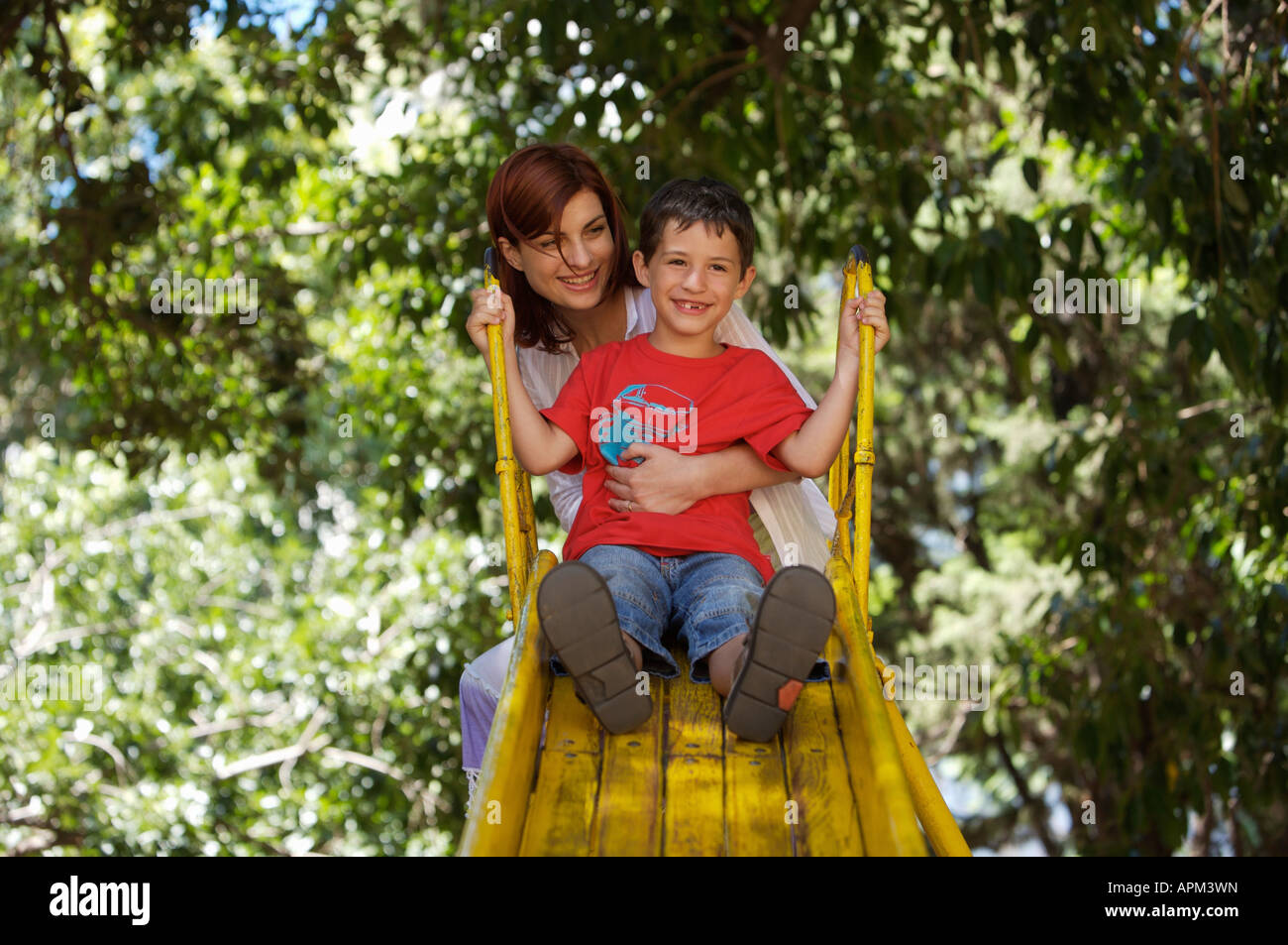 Mother and children in playground Stock Photo - Alamy
