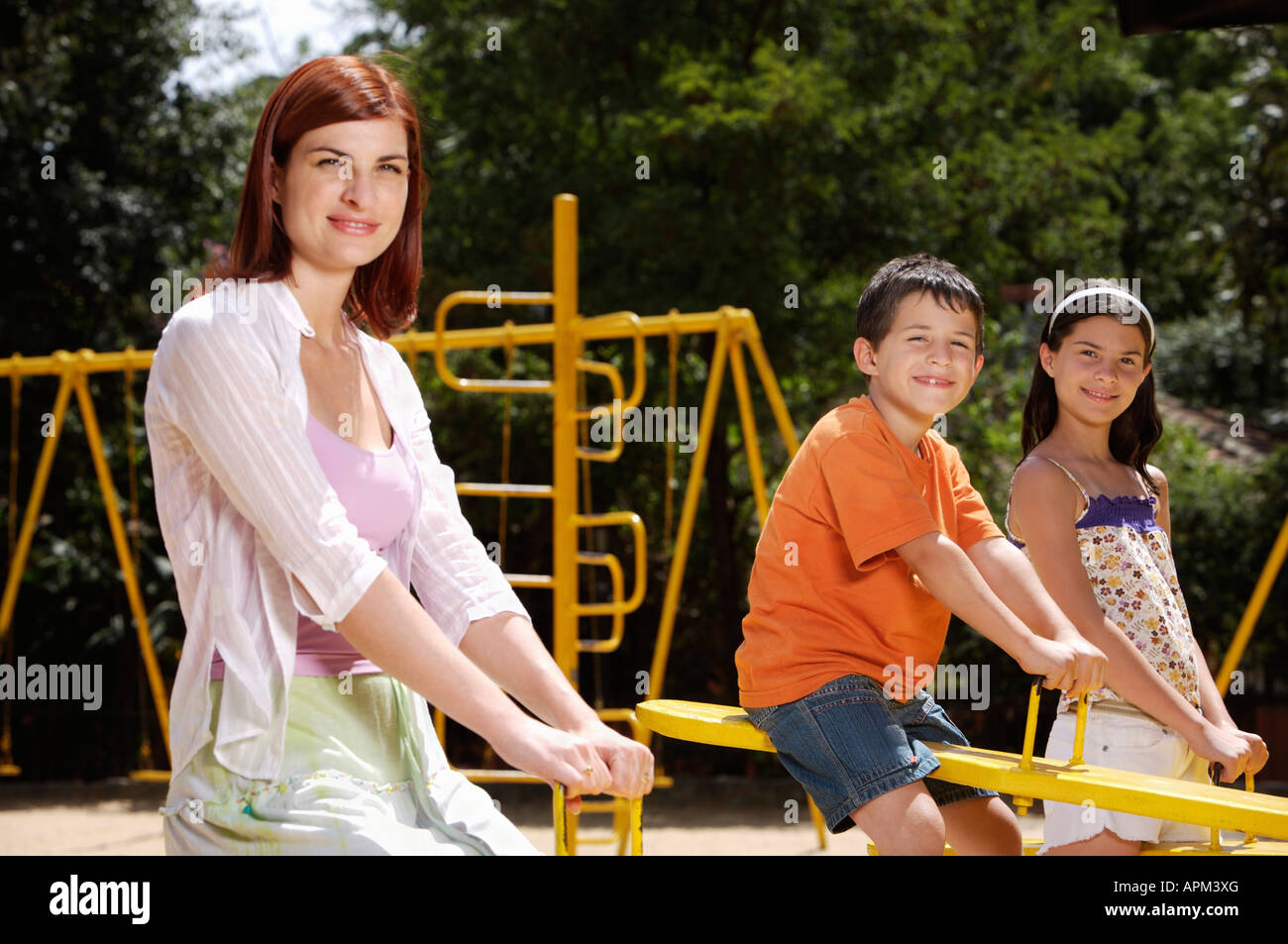 Mother and children in playground Stock Photo - Alamy