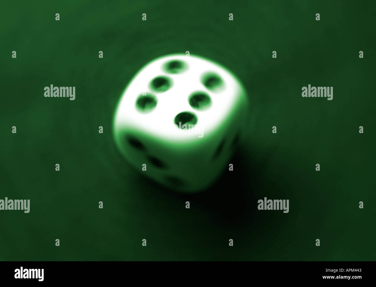 Semi abstract image of white die on green background with six showing ...
