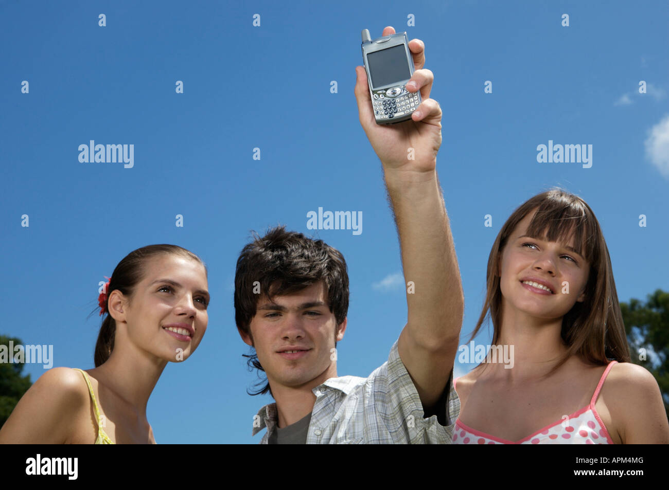 Teenagers using electronic agenda and celullar phone phone Stock Photo ...