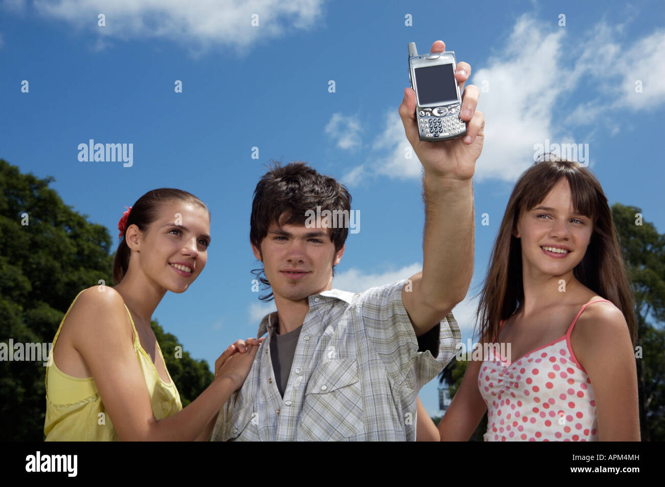 Teenagers using electronic agenda and celullar phone Stock Photo - Alamy