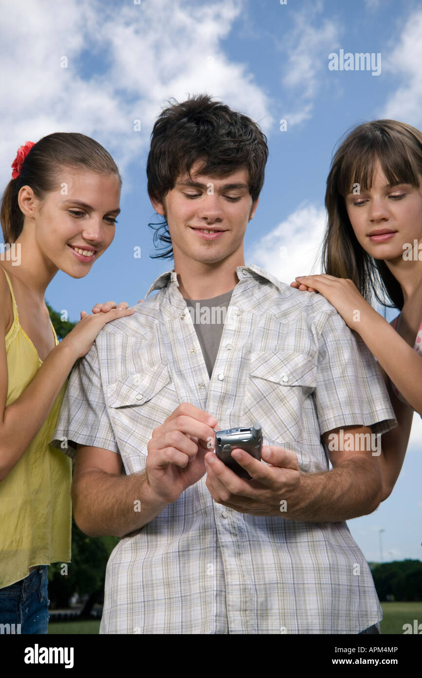 Teenagers using electronic agenda and celullar phone Stock Photo - Alamy
