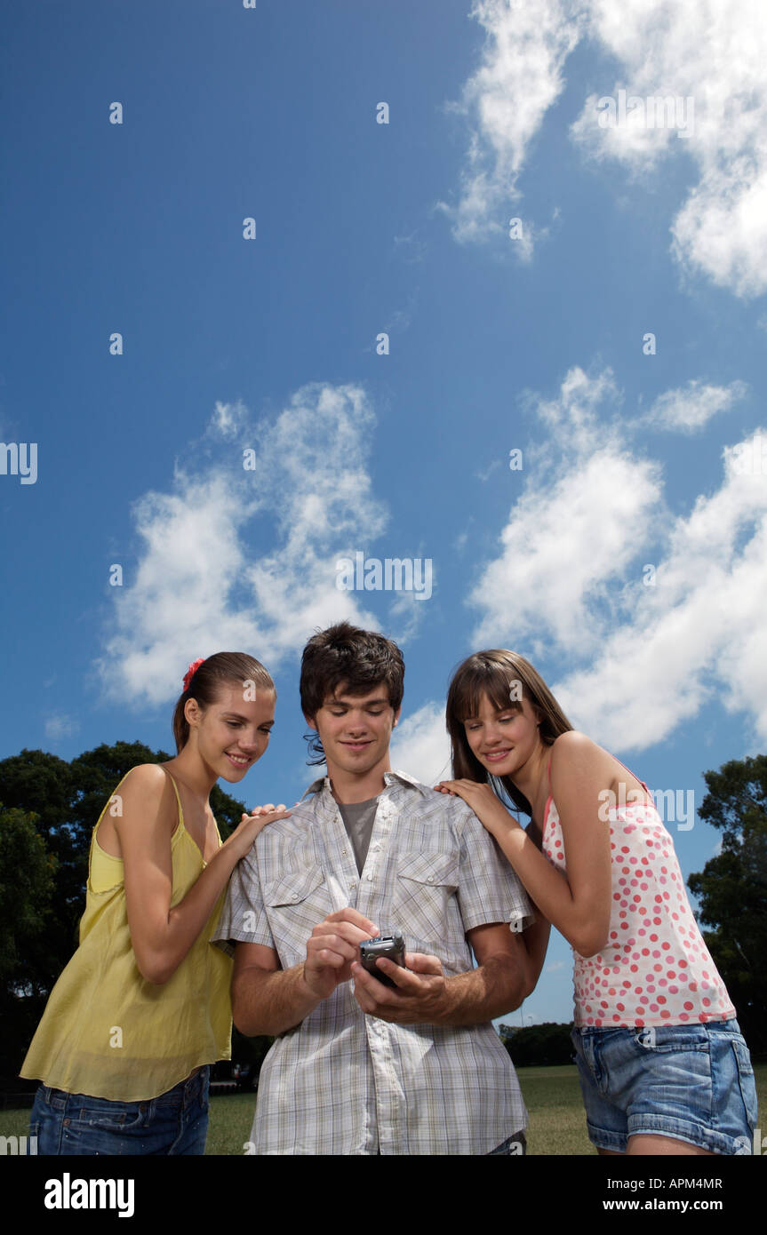 Teenagers using electronic agenda and celullar phone Stock Photo - Alamy
