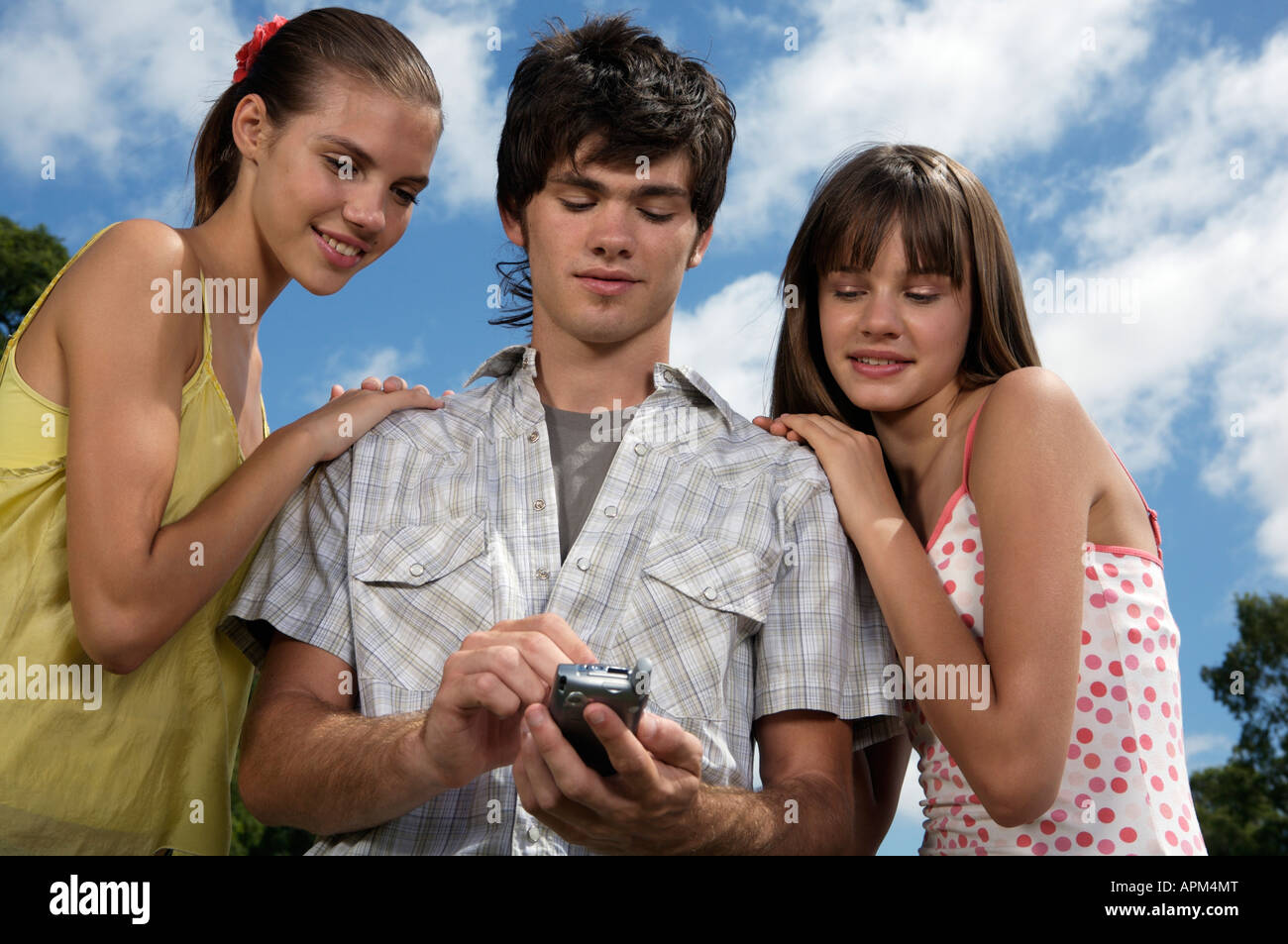 Teenagers using electronic agenda and celullar phone Stock Photo - Alamy