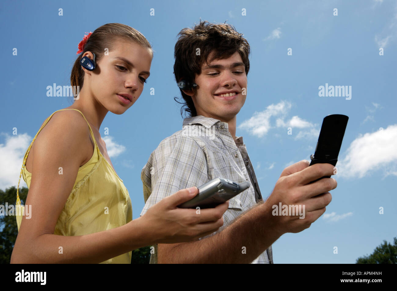 Teenagers using electronic agenda and celullar phone Stock Photo - Alamy
