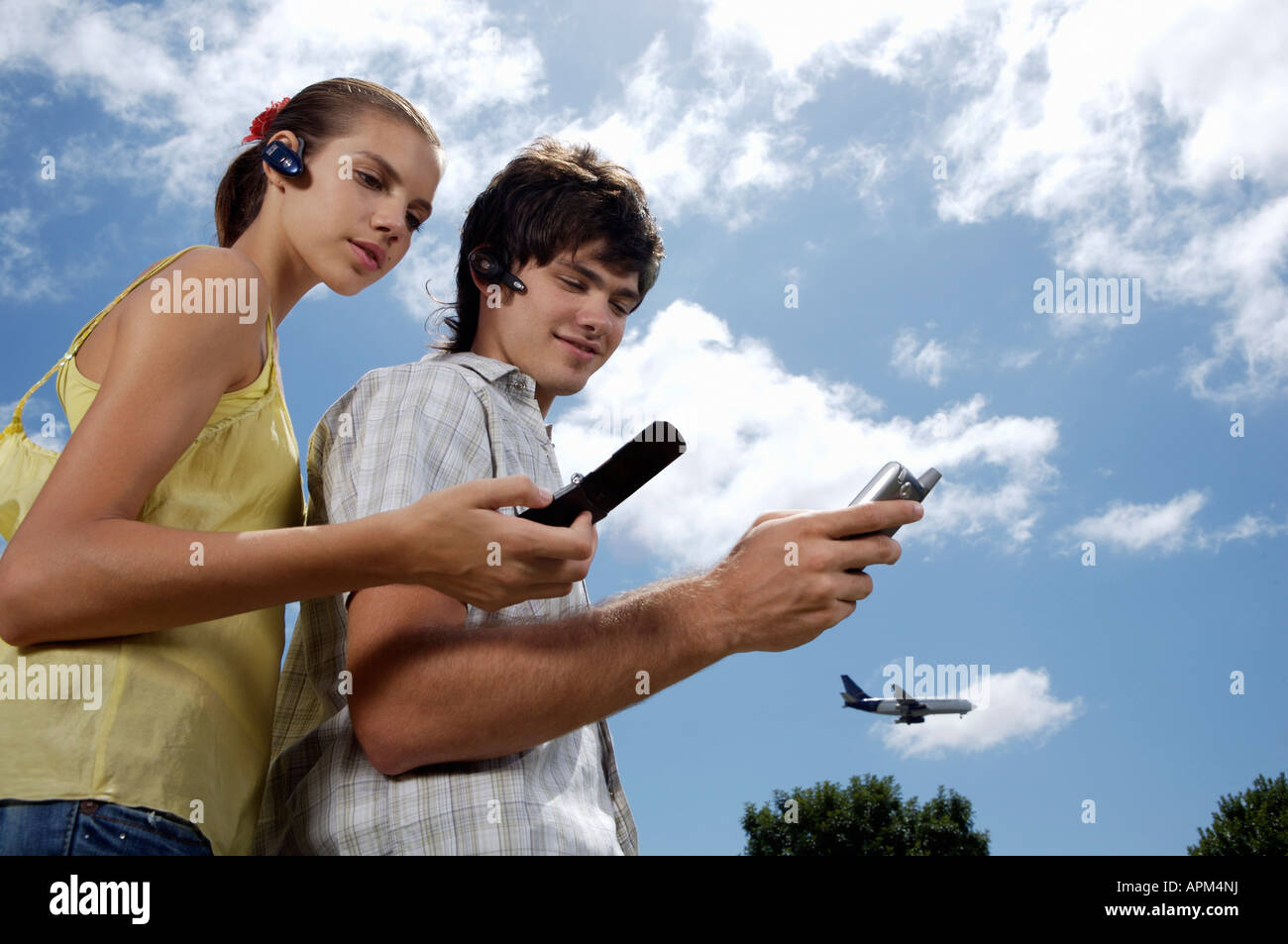 Teenagers using electronic agenda and celullar phone Stock Photo - Alamy