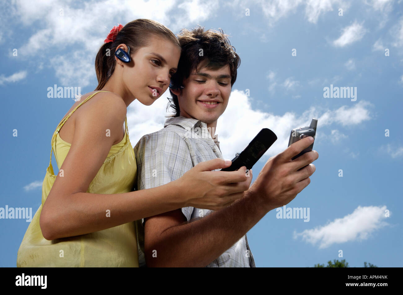 Teenagers using electronic agenda and celullar phone Stock Photo - Alamy