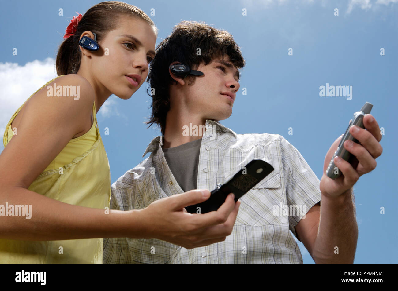 Teenagers using electronic agenda and celullar phone Stock Photo - Alamy