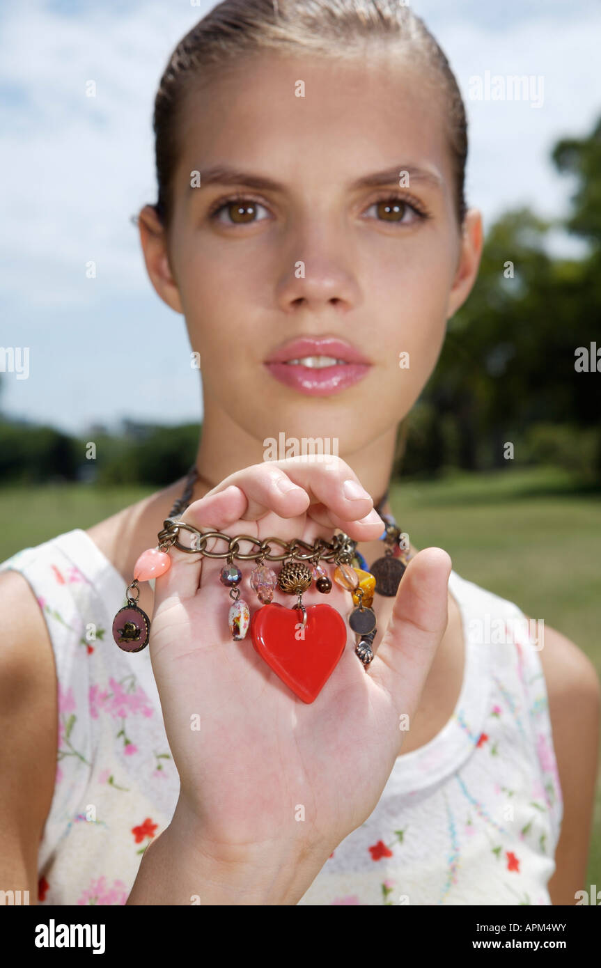 Teenage girl holding a necklace Stock Photo - Alamy