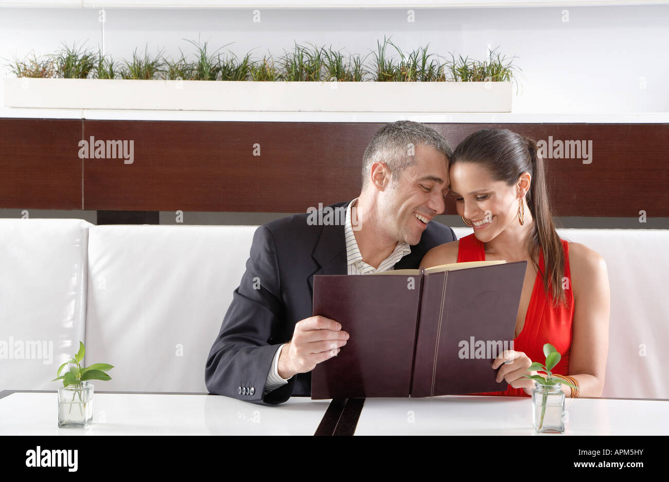 Couple reading menu in restaurant Stock Photo - Alamy