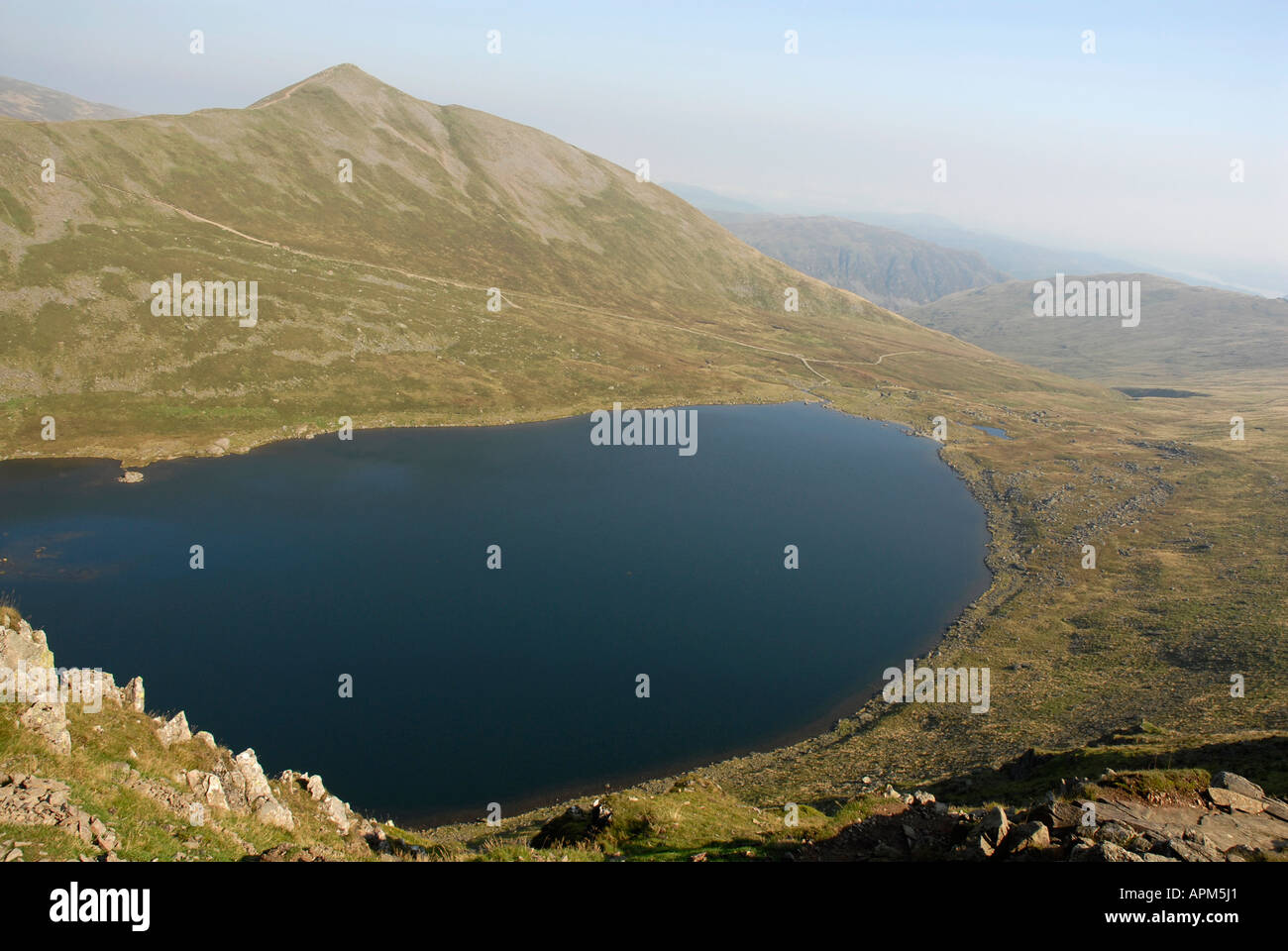 Red Tarn sits below Striding Edge in the Lake District, Cumbria ...