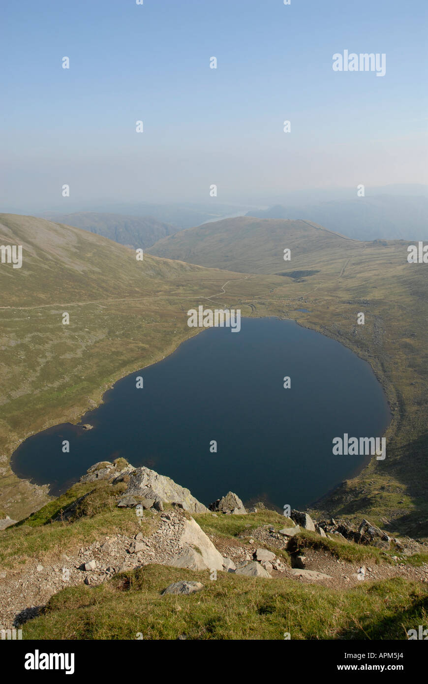 Red Tarn sits below Striding Edge in the Lake District Cumbria, England ...