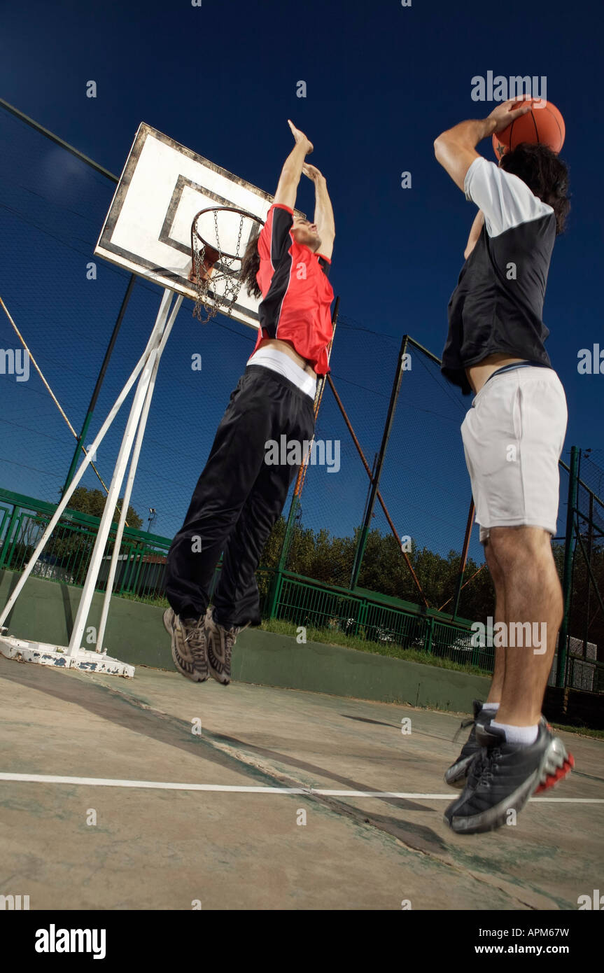 Two young men playing basketball Stock Photo - Alamy