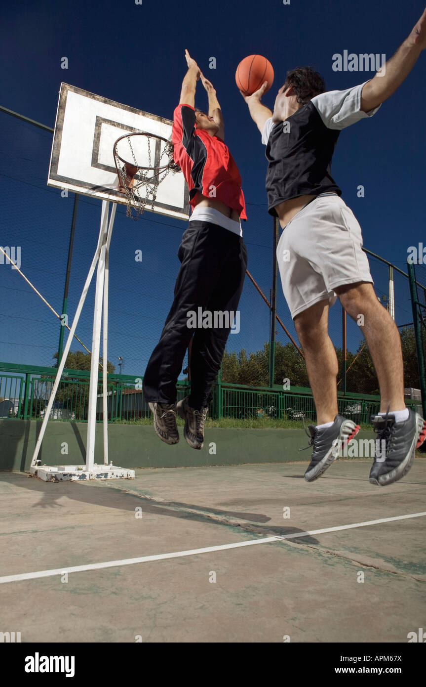 Two young men playing basketball Stock Photo - Alamy
