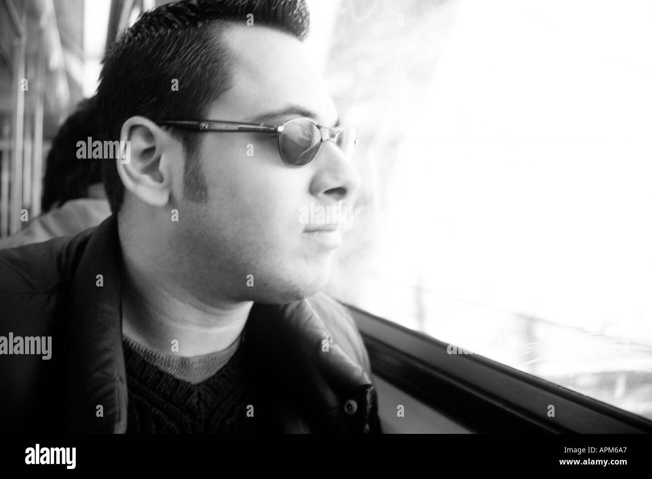 A man riding a subway looking out the window New York City USA Stock ...