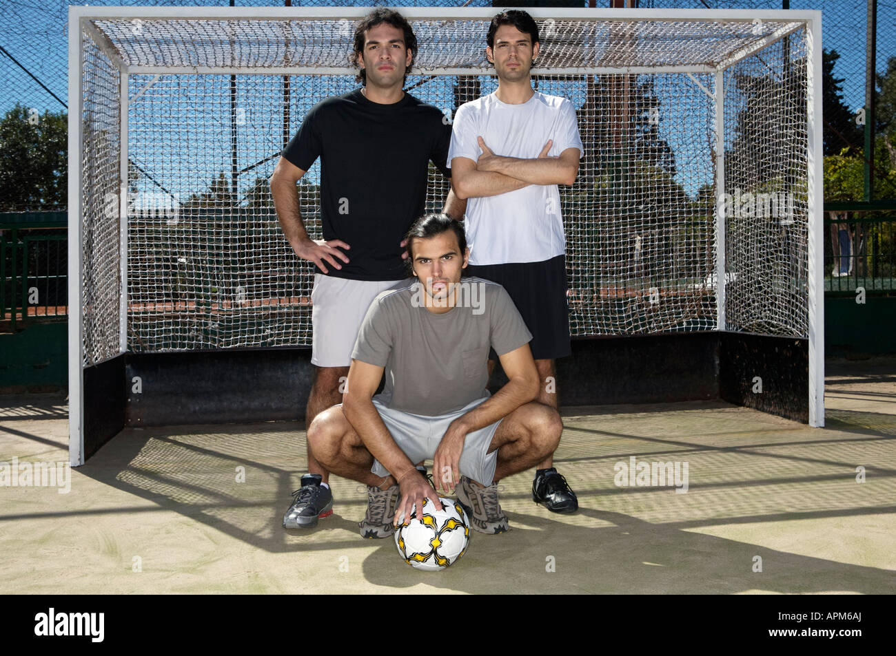 Friends playing football Stock Photo - Alamy
