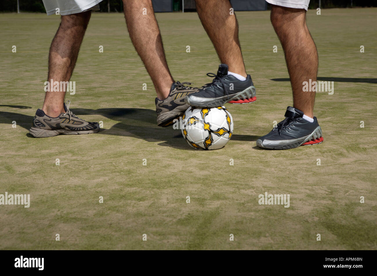 Friends playing football Stock Photo - Alamy