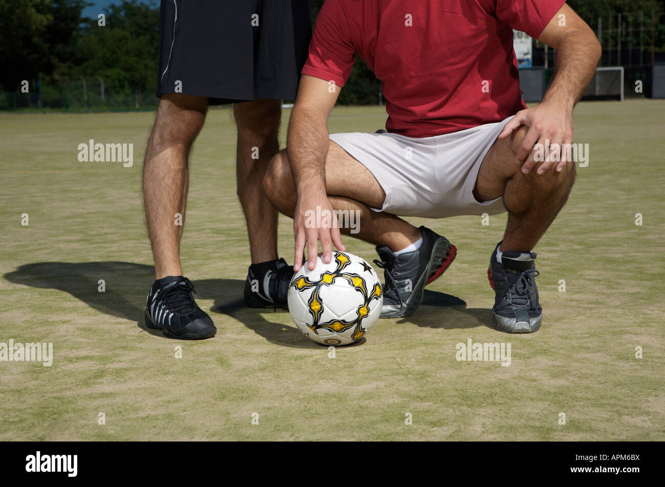 Friends playing football Stock Photo - Alamy