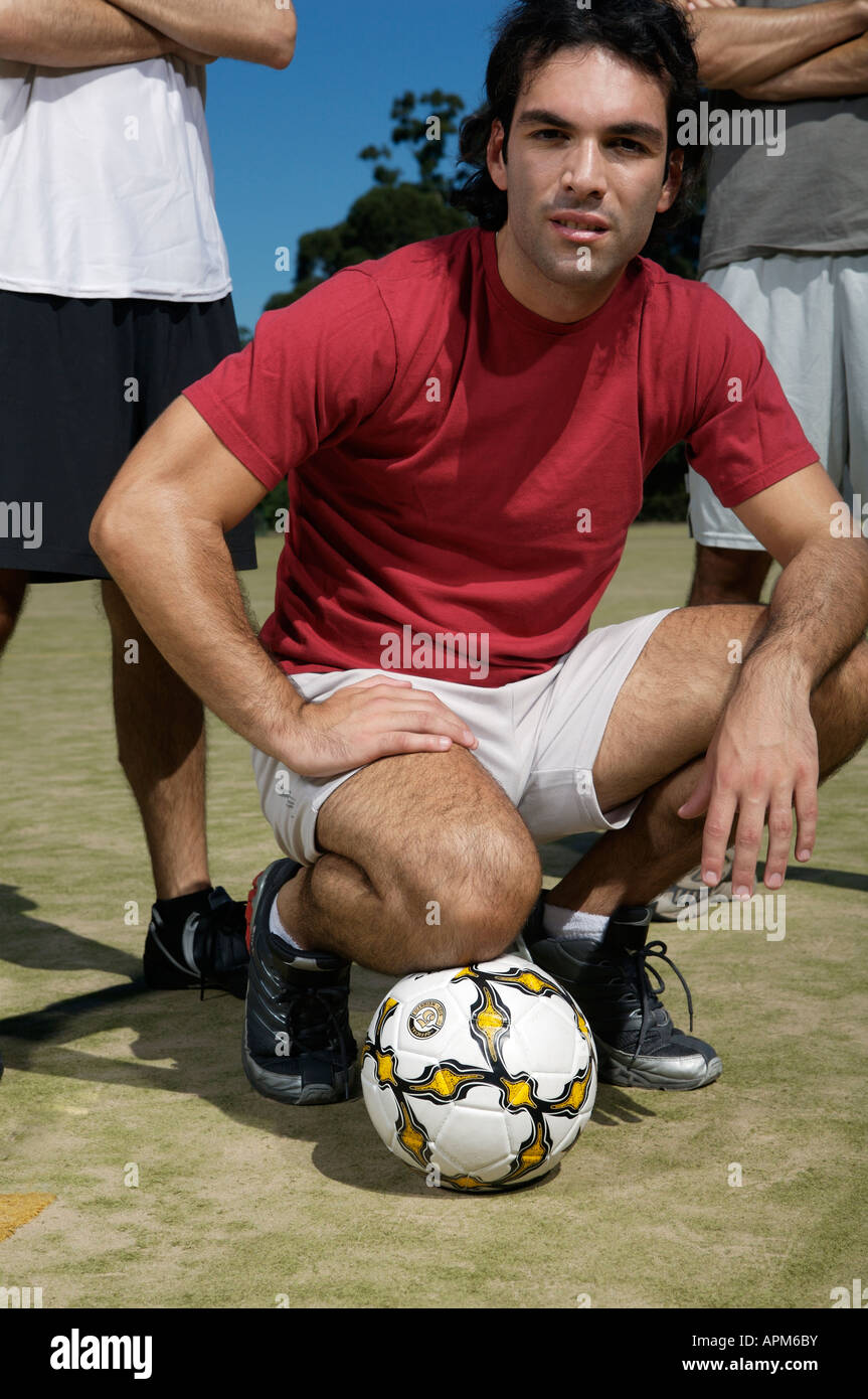 Friends playing football Stock Photo - Alamy