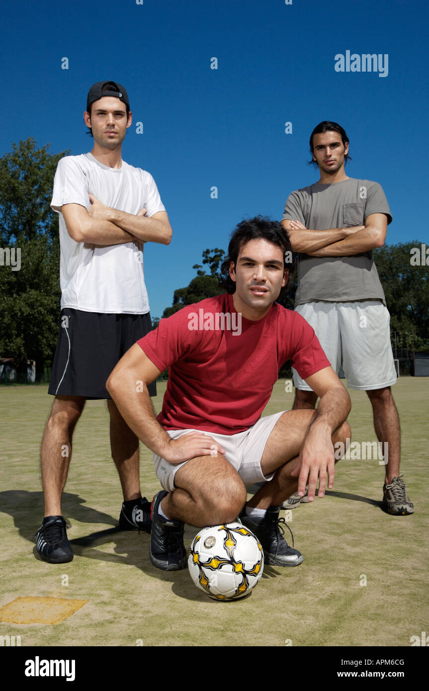 Friends playing football Stock Photo - Alamy