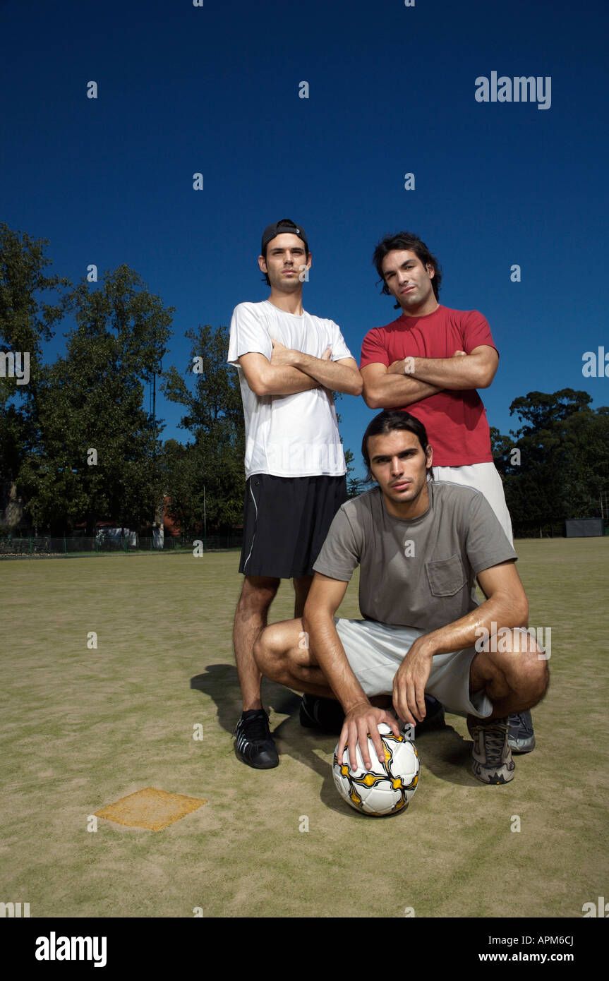 Friends playing football Stock Photo - Alamy