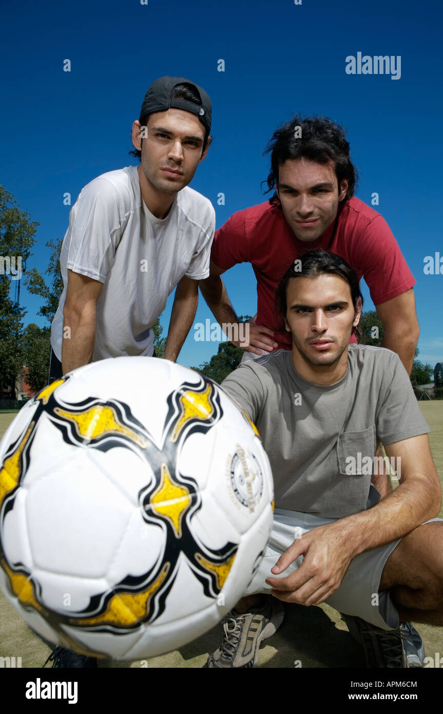 Friends playing football Stock Photo - Alamy