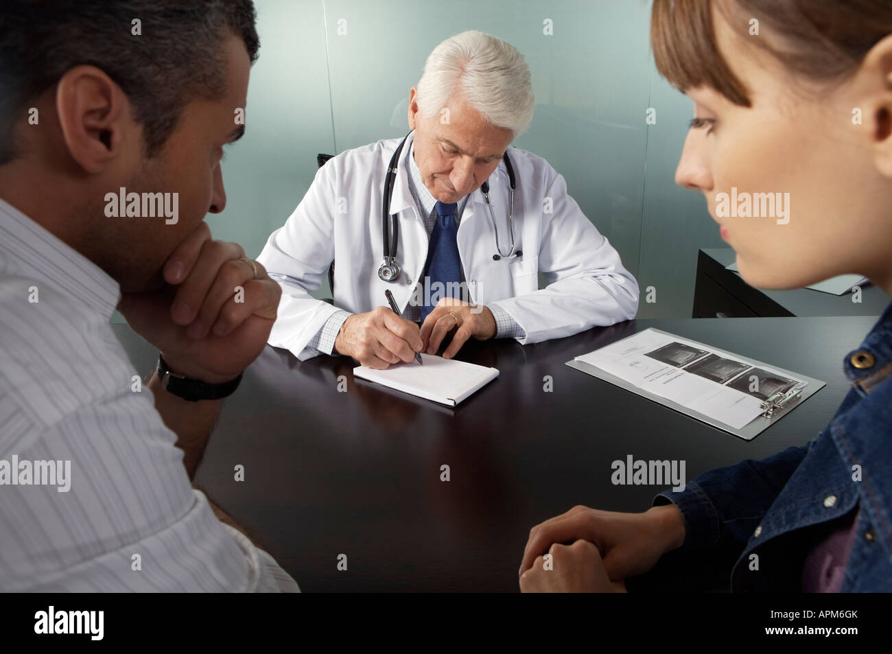 Doctor with patient at office Stock Photo - Alamy