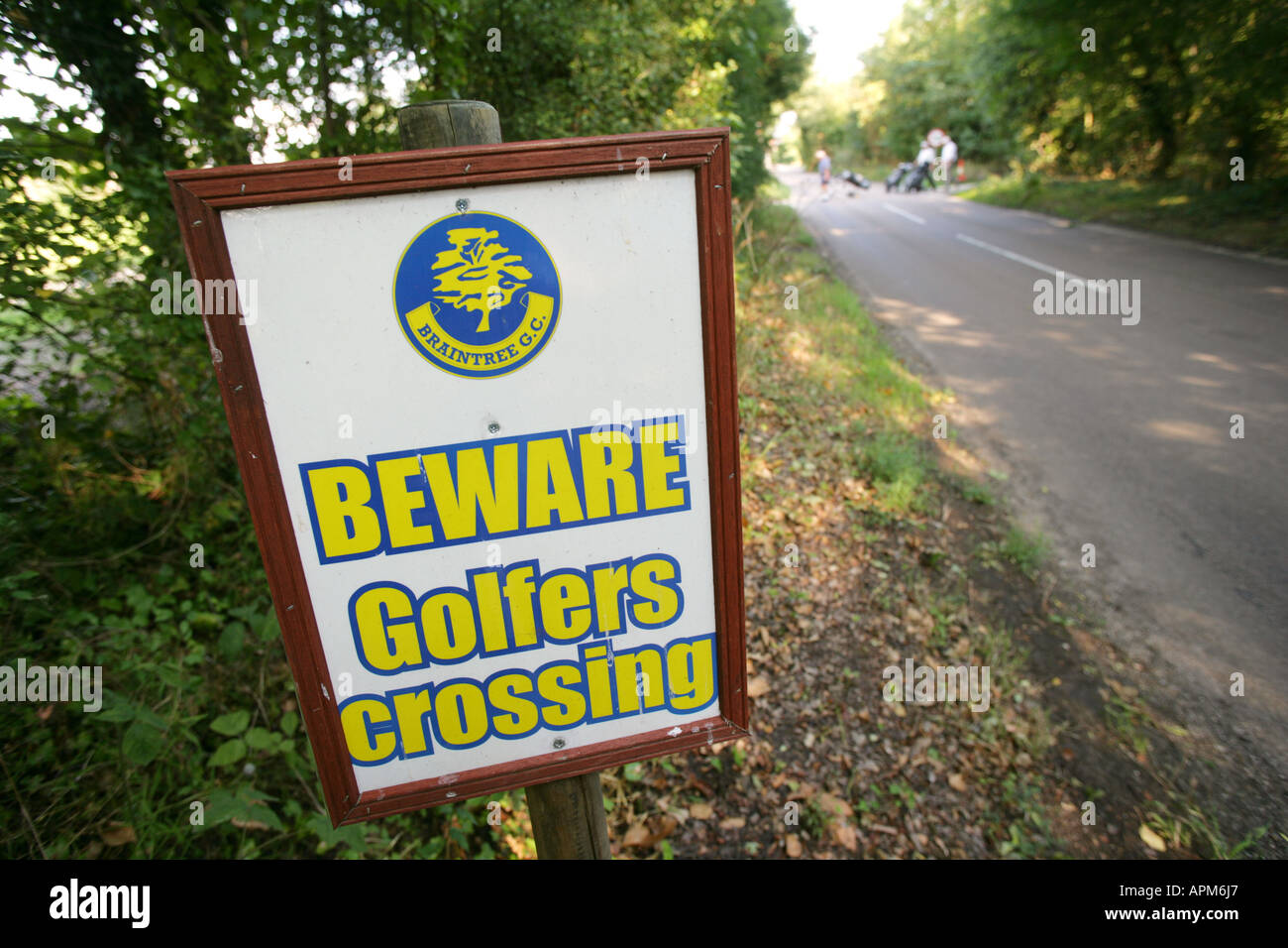"Beware Golfers Crossing" sign on country road crossing a golf course ...