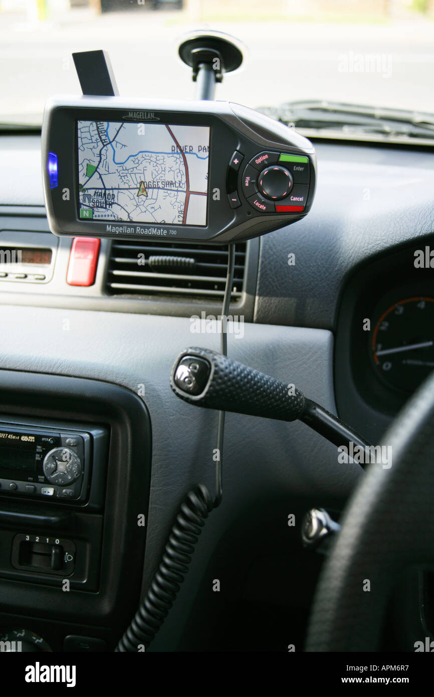 Portable satellite navigation system affixed to car windscreen, England ...