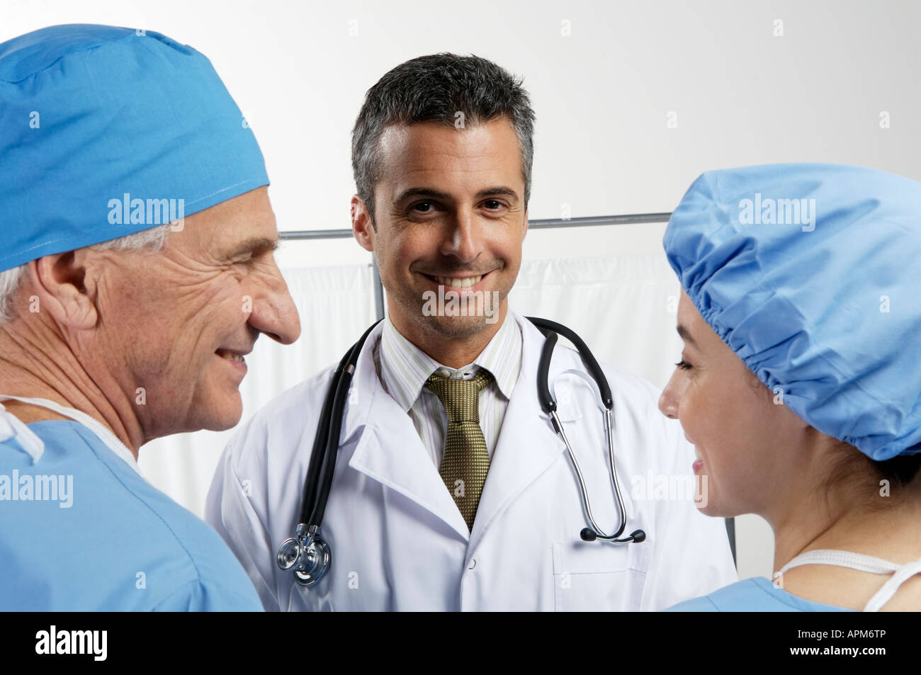 Three doctors talking Stock Photo - Alamy