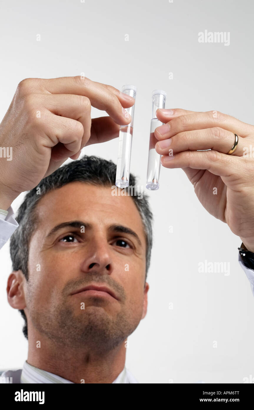 Lab doctor looking at test tubes Stock Photo - Alamy
