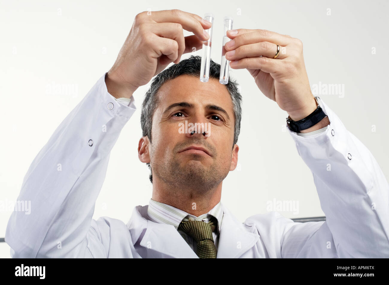 Lab doctor looking at test tubes Stock Photo - Alamy