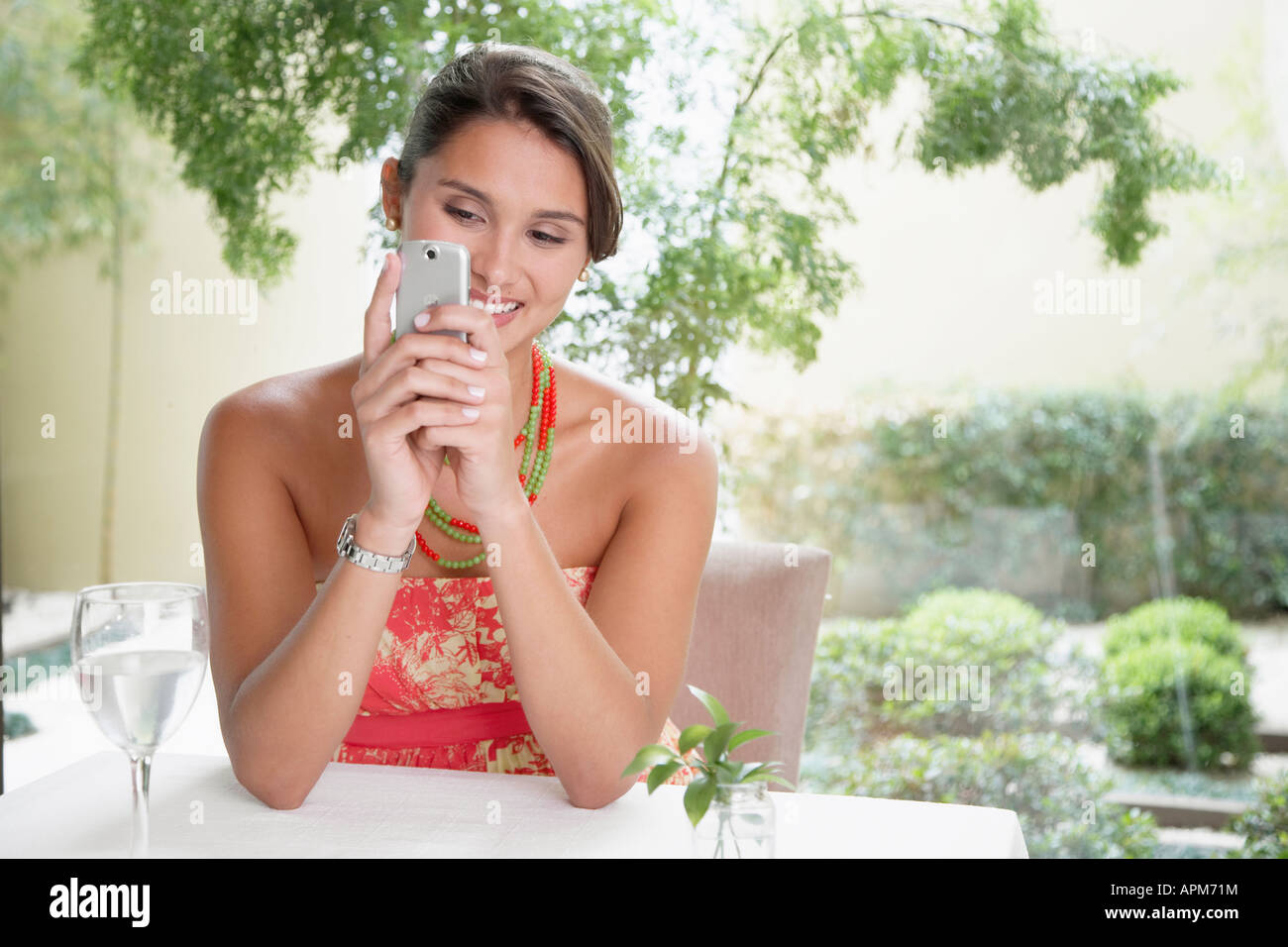 Woman reading text message at dining table Stock Photo - Alamy
