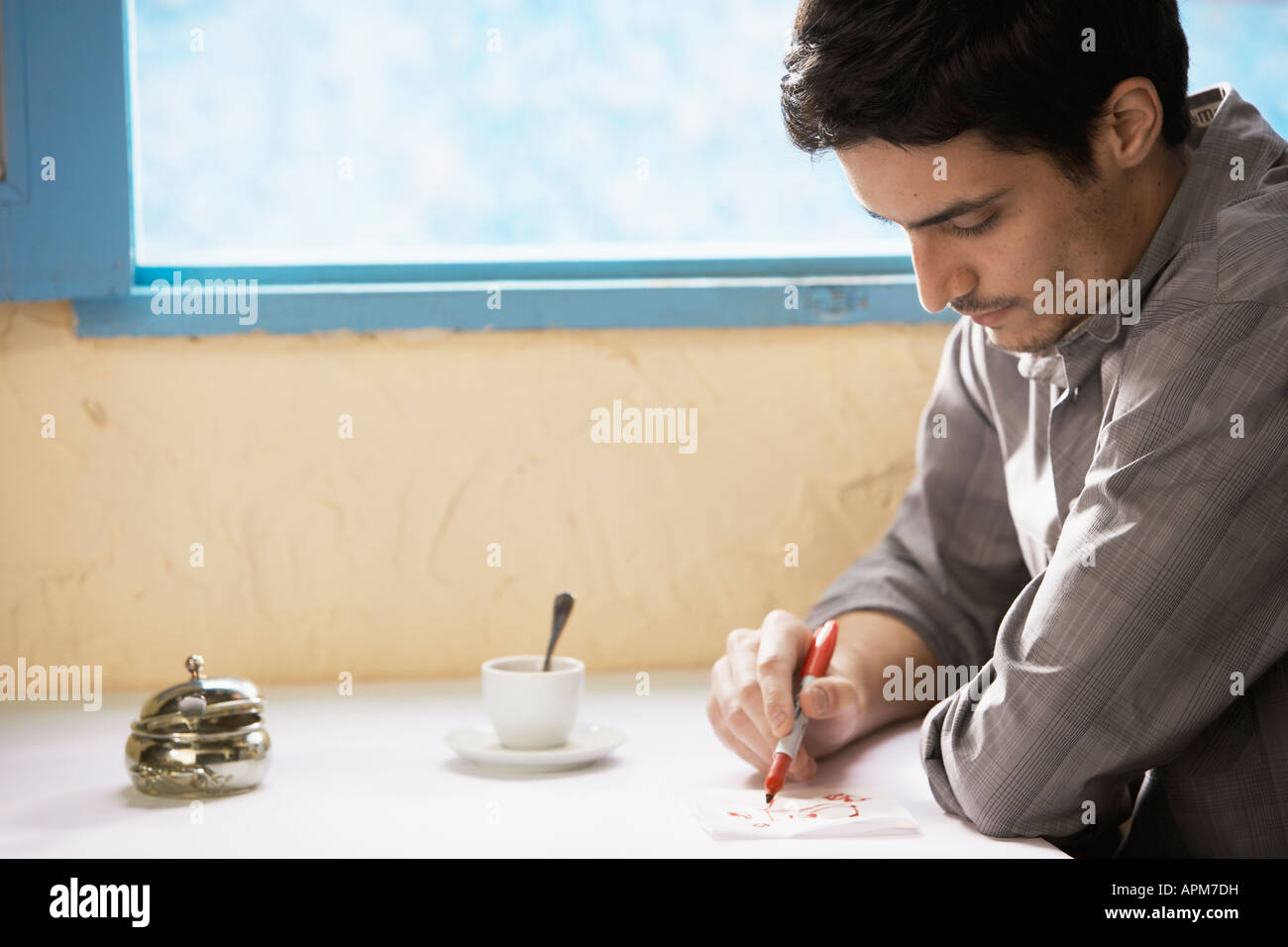 Man drawing on paper napkin Stock Photo - Alamy