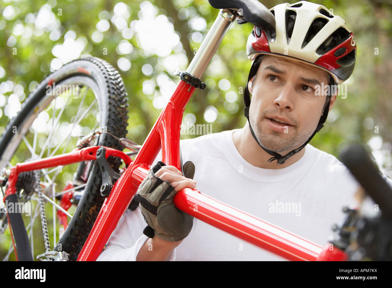 Mid adult man carrying bicycle Stock Photo - Alamy