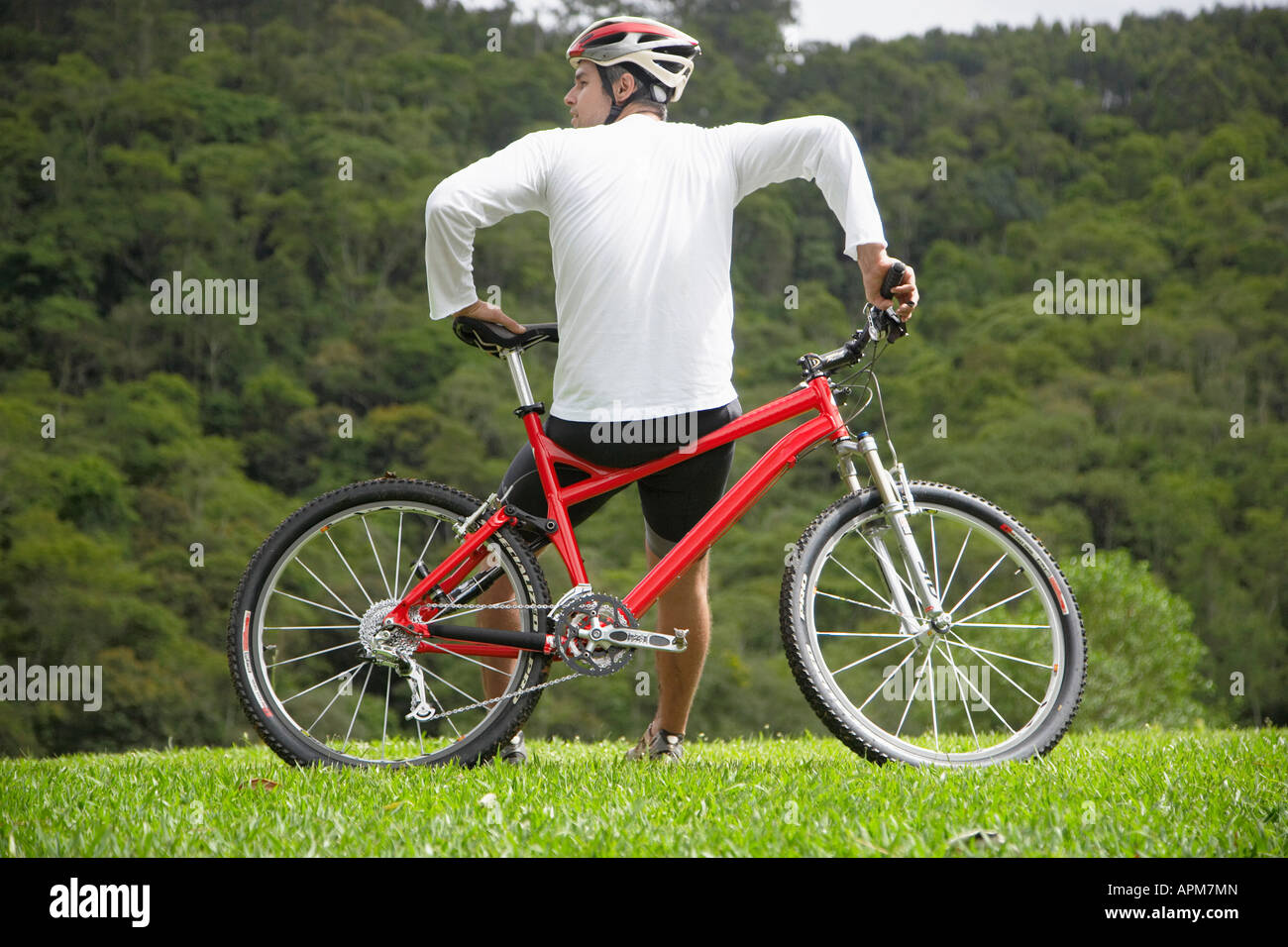 Mid adult man leaning on mountain bike, rear view Stock Photo - Alamy