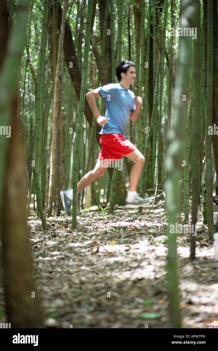 Young man running in forest Stock Photo - Alamy