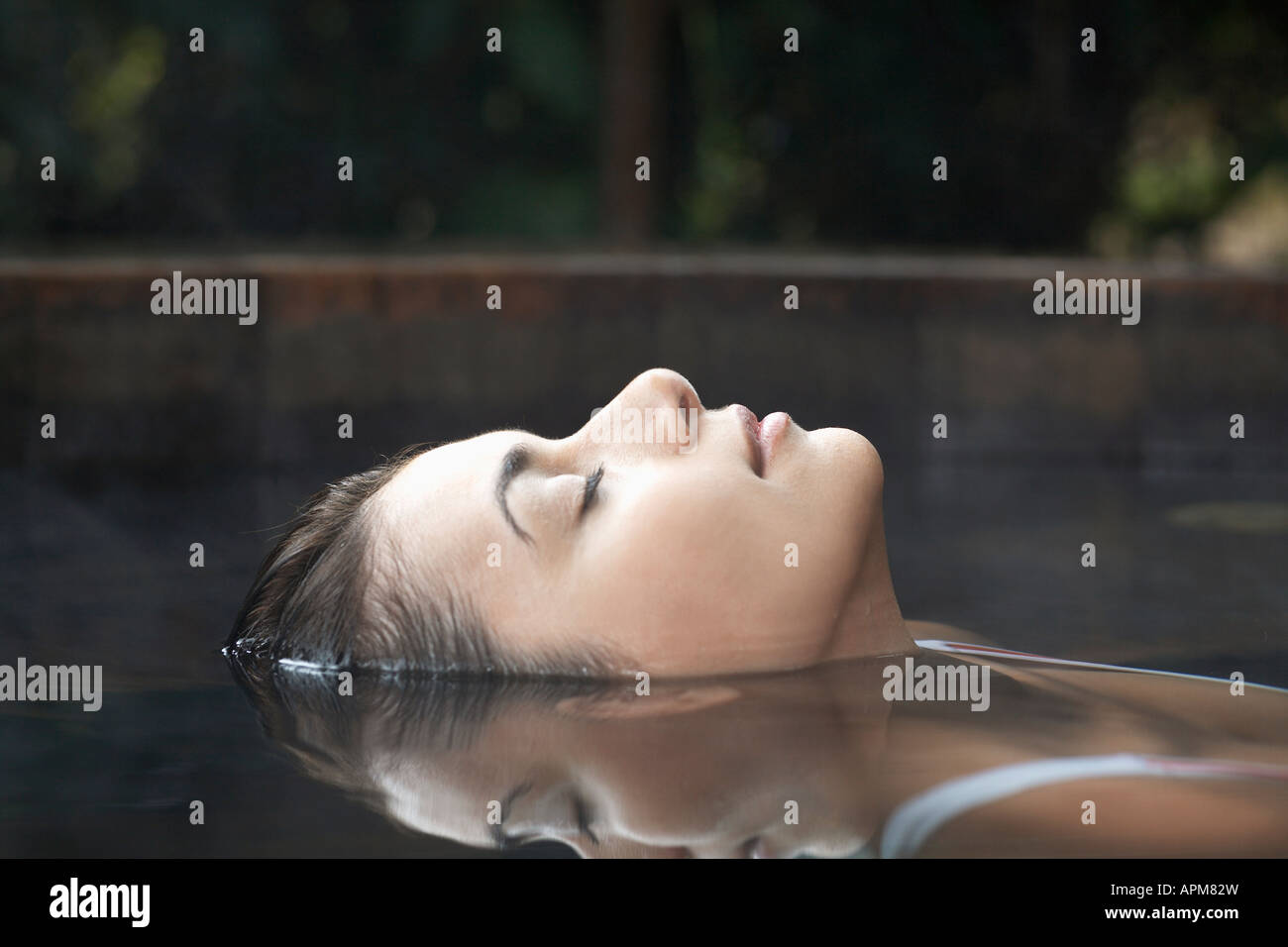 Young woman floating in Jacuzzi Stock Photo - Alamy