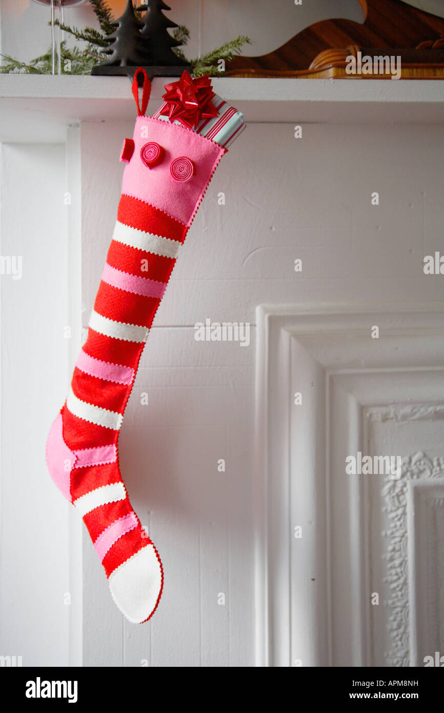 Christmas stocking with presents hanging from shelf Stock Photo - Alamy