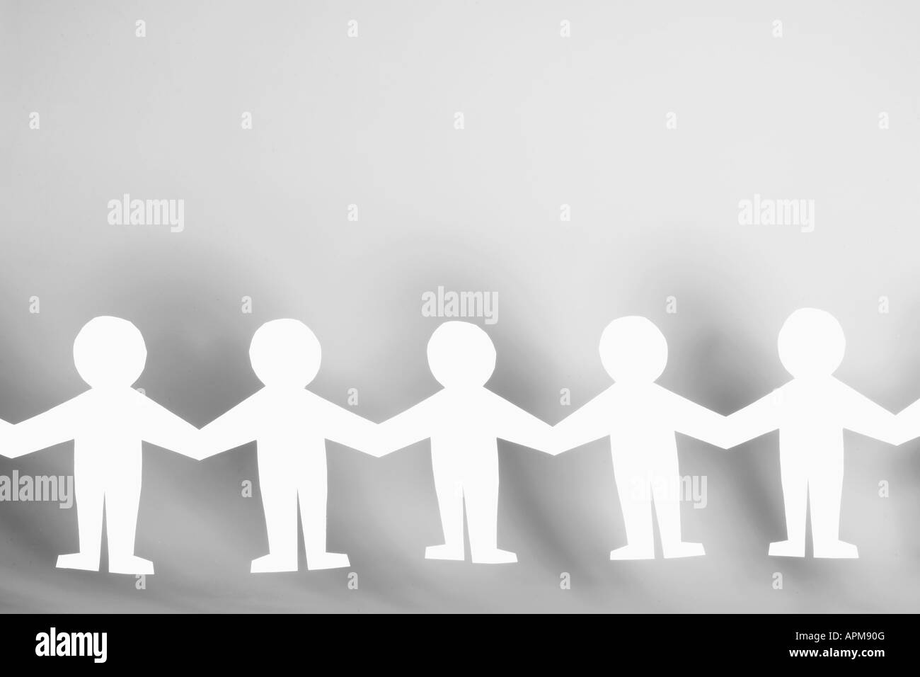 Row of white paper figurines (close-up Stock Photo - Alamy